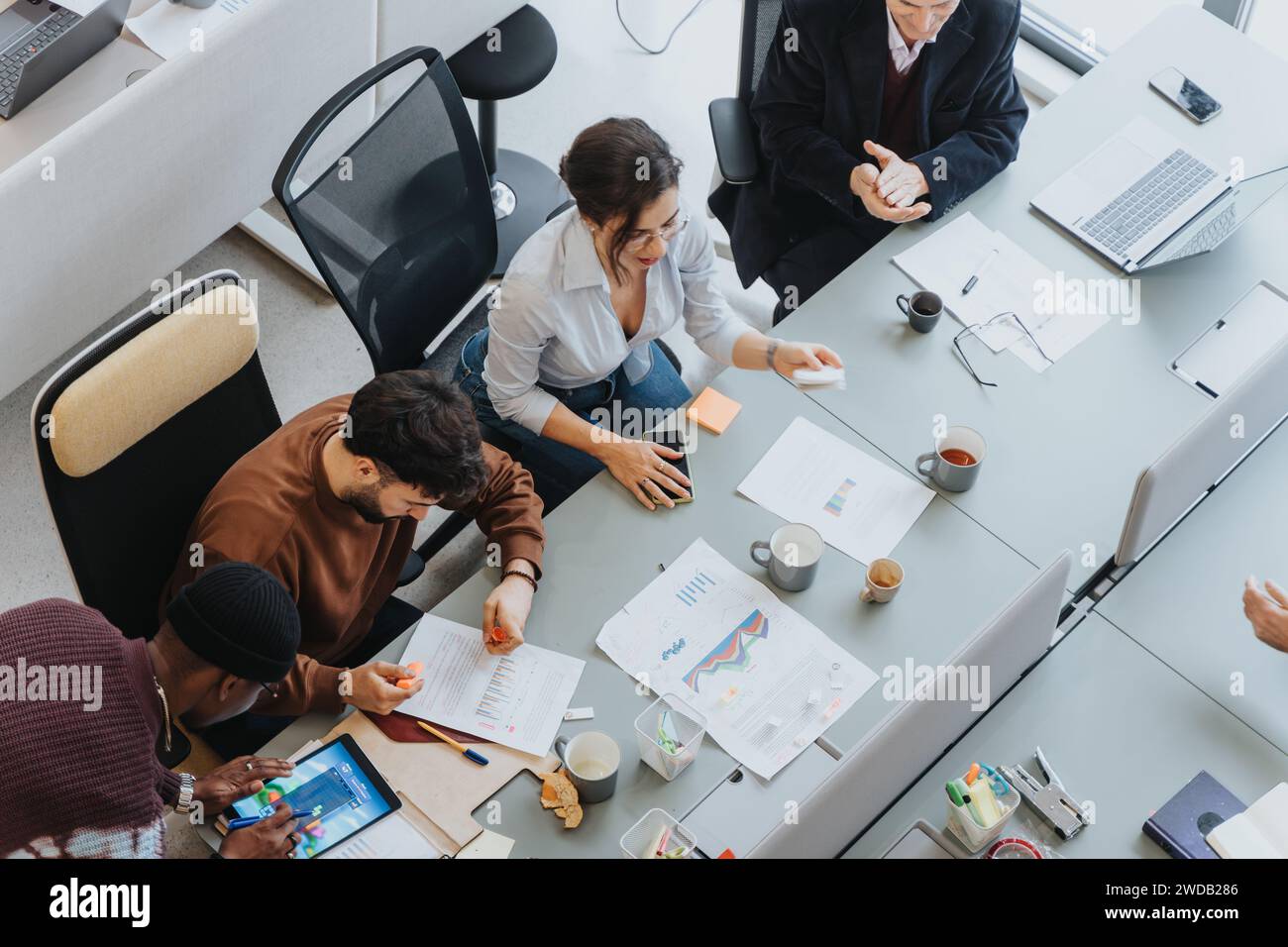 Multicultural people sitting around table hi-res stock photography and ...