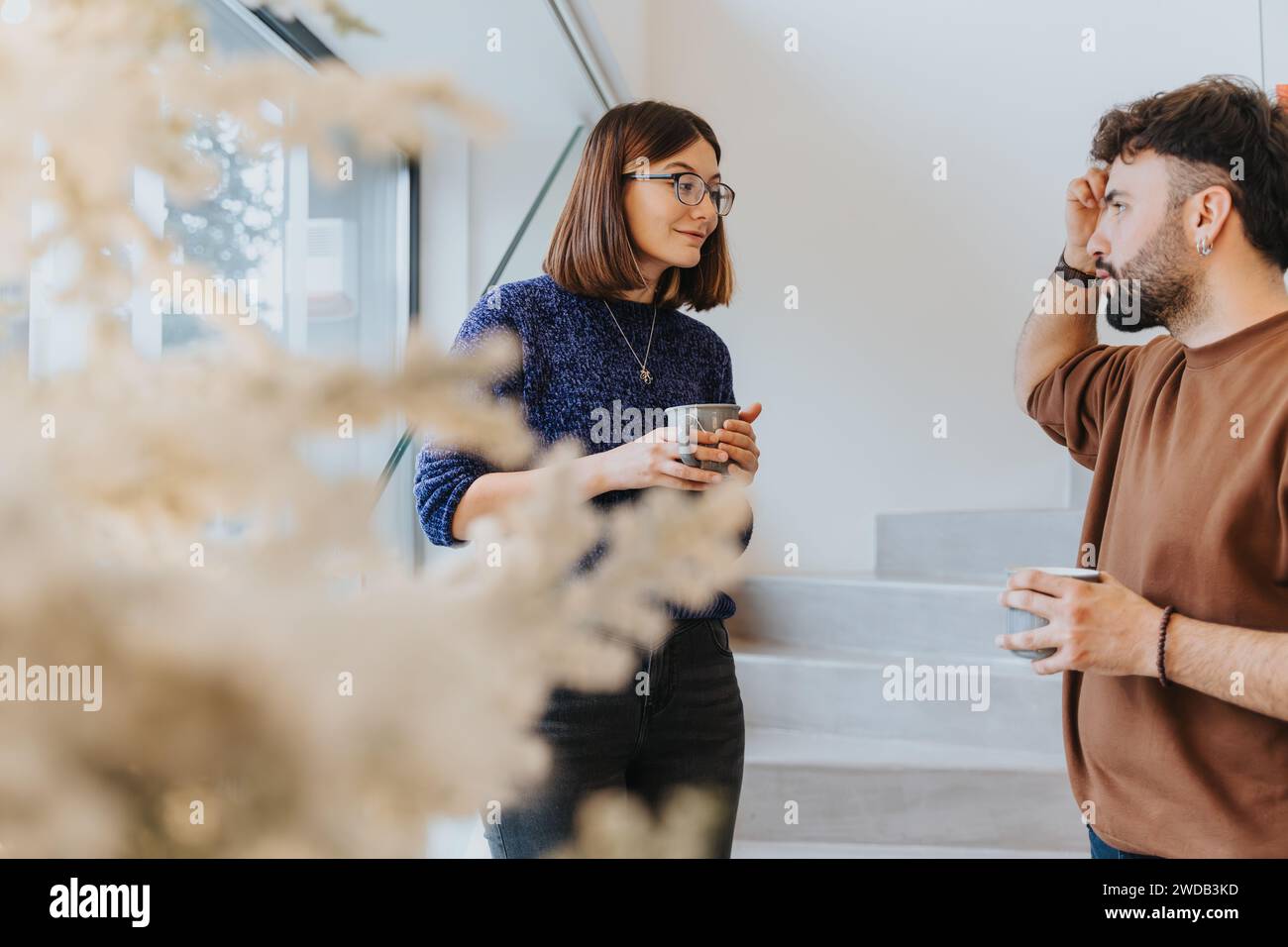 Colleagues engaging in a relaxed conversation during a coffee break in ...