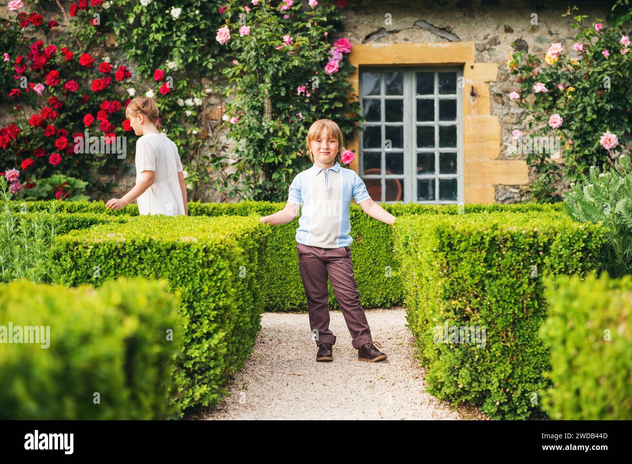 Two kids, little boy and girl, posing in beautiful classical English ...