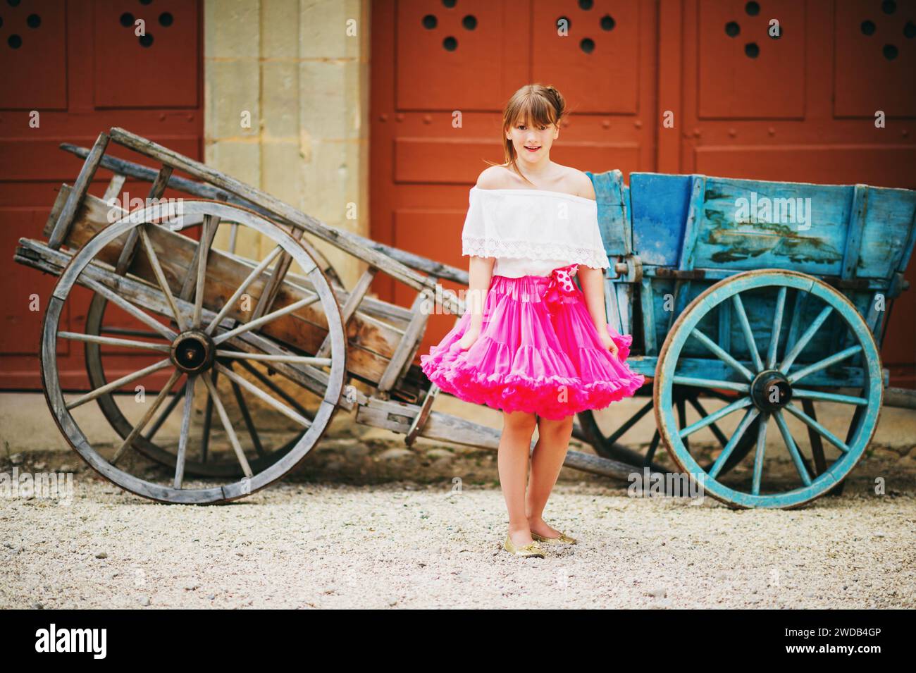 Outdoor portrait of sweet little girl wearing bright pink tutu skirt ...
