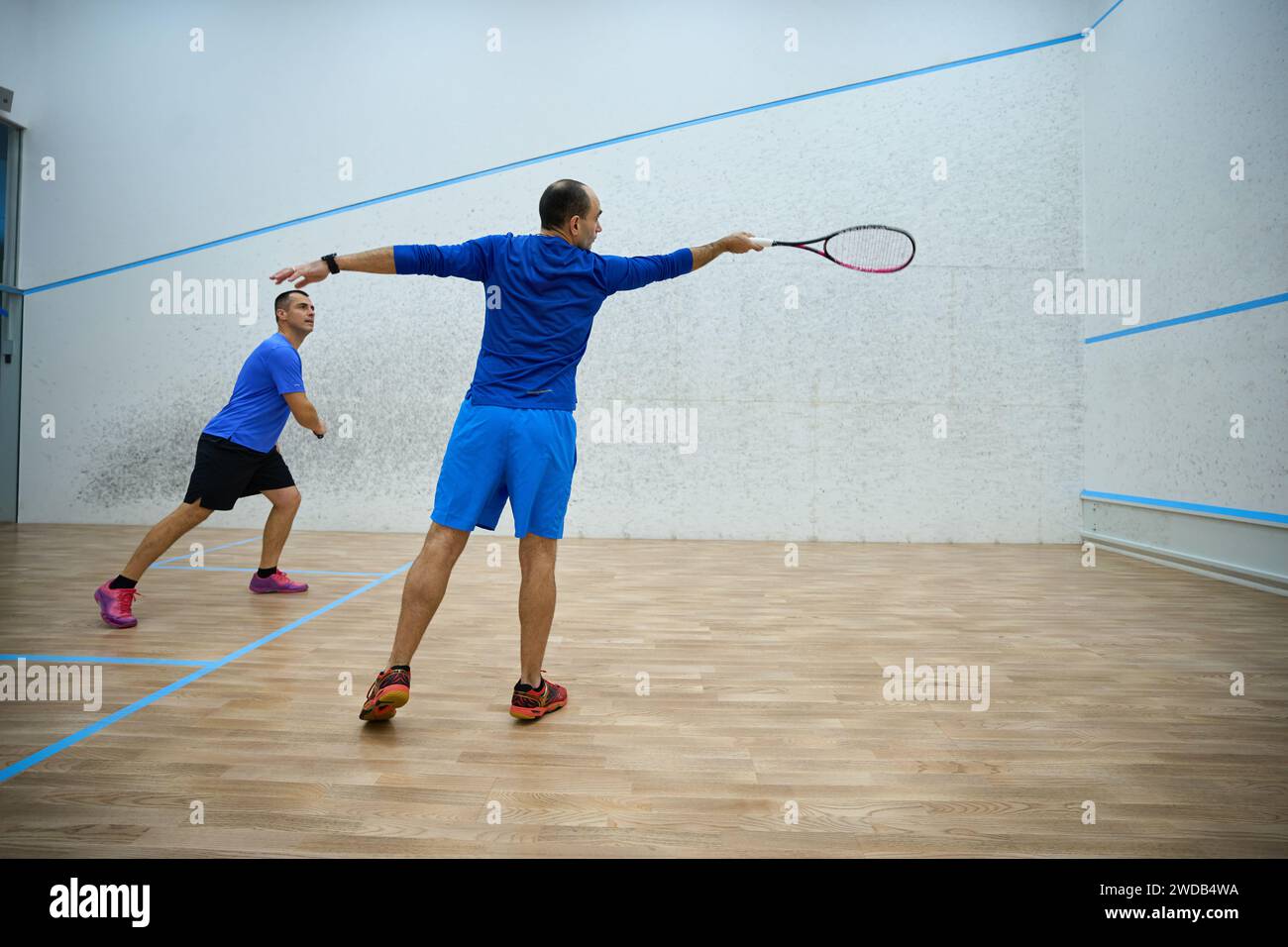 Energetic men training for squash enjoying active lifestyle Stock Photo ...