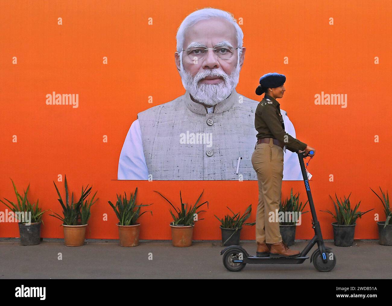 Ahmedabad, India. 13th Jan, 2024. A police officer rides an electric ...