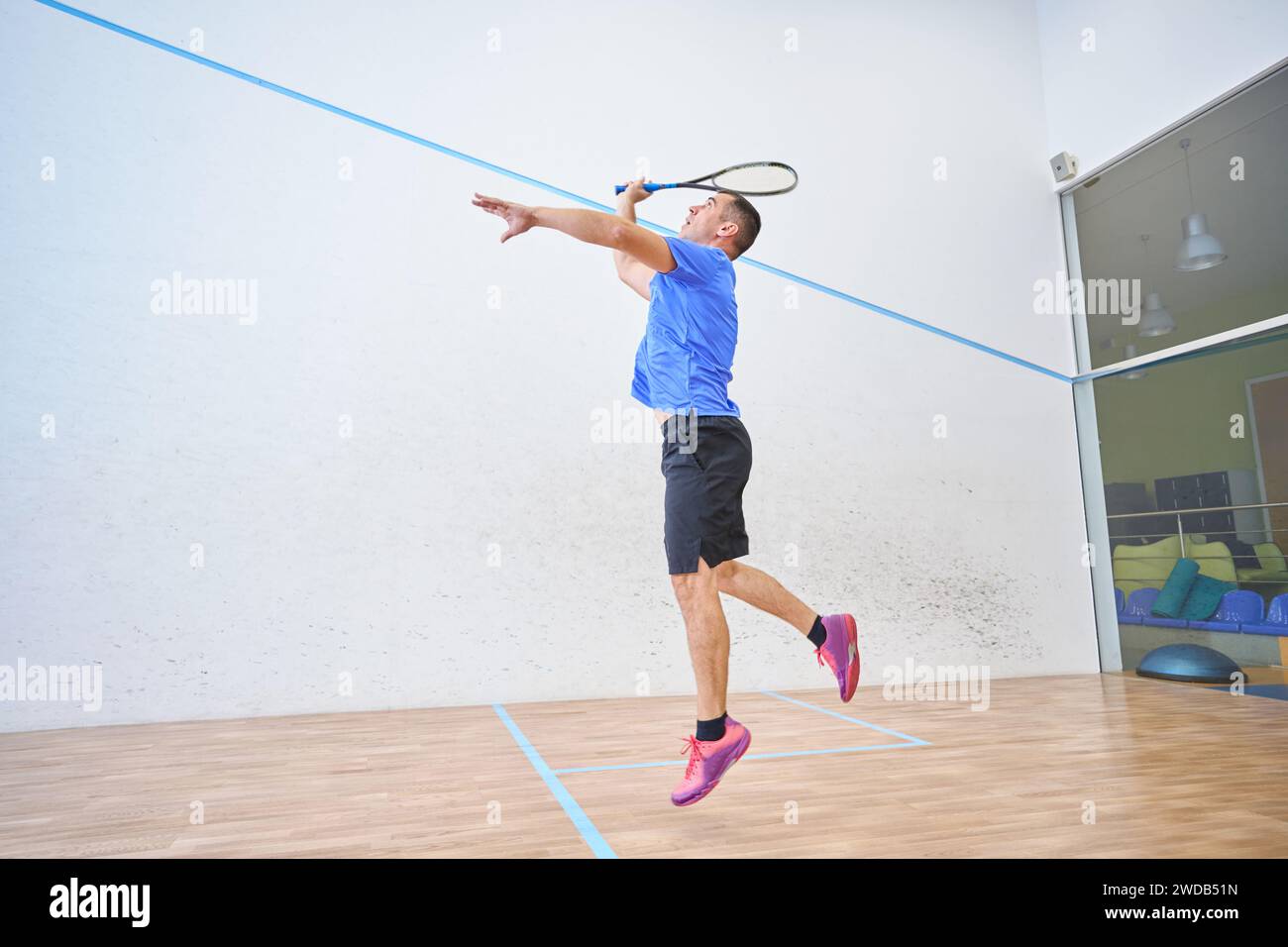 Slim sporty man is playing squash alone Stock Photo - Alamy