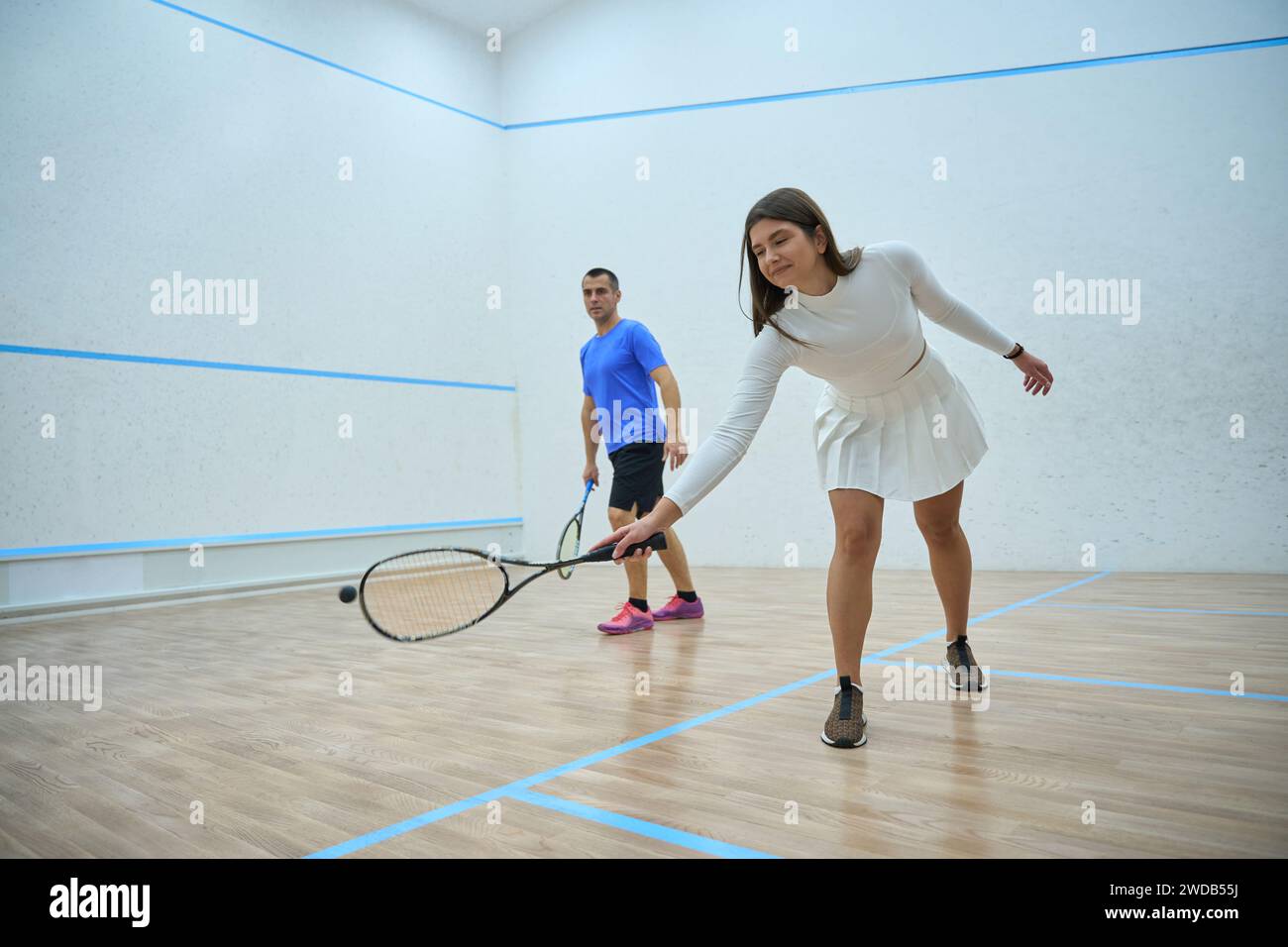 Athletic man and woman improving squash techniques Stock Photo - Alamy