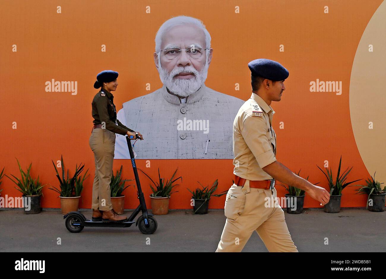 Ahmedabad, India. 13th Jan, 2024. A police officer rides an electric ...