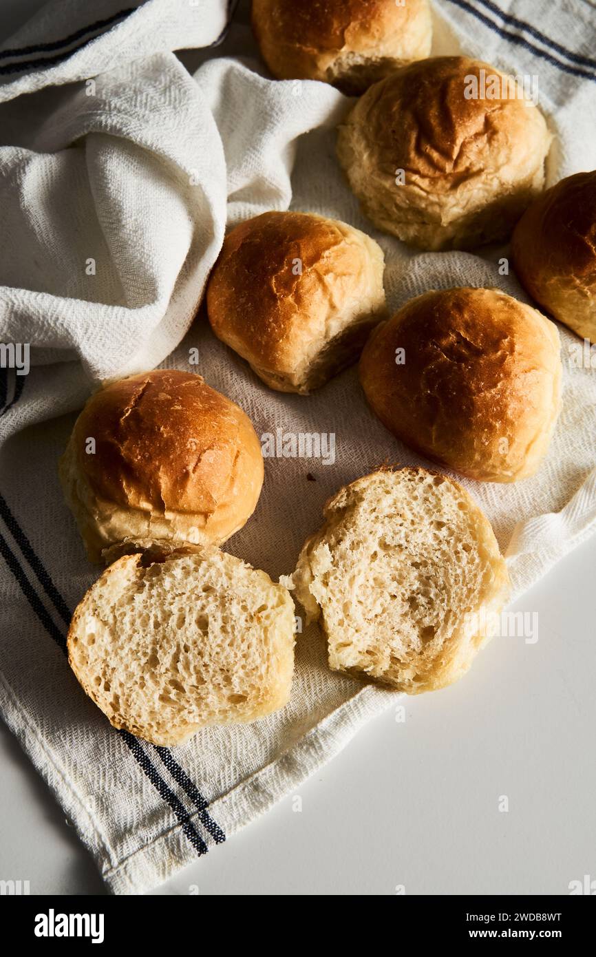 Burger Buns or mini buns on white marble background and kitchen towel ...