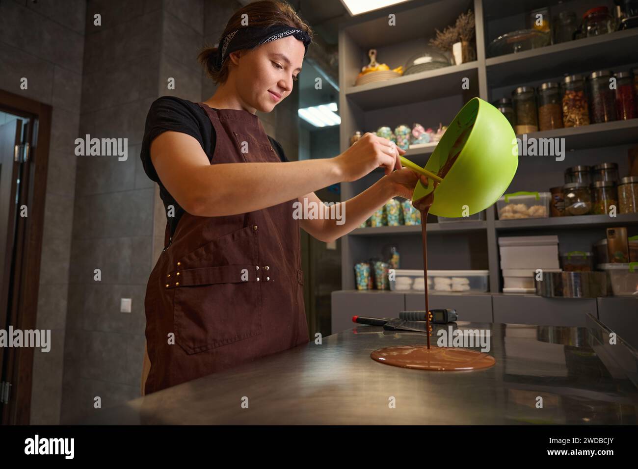 Young female confectioner busy with candy making Stock Photo - Alamy