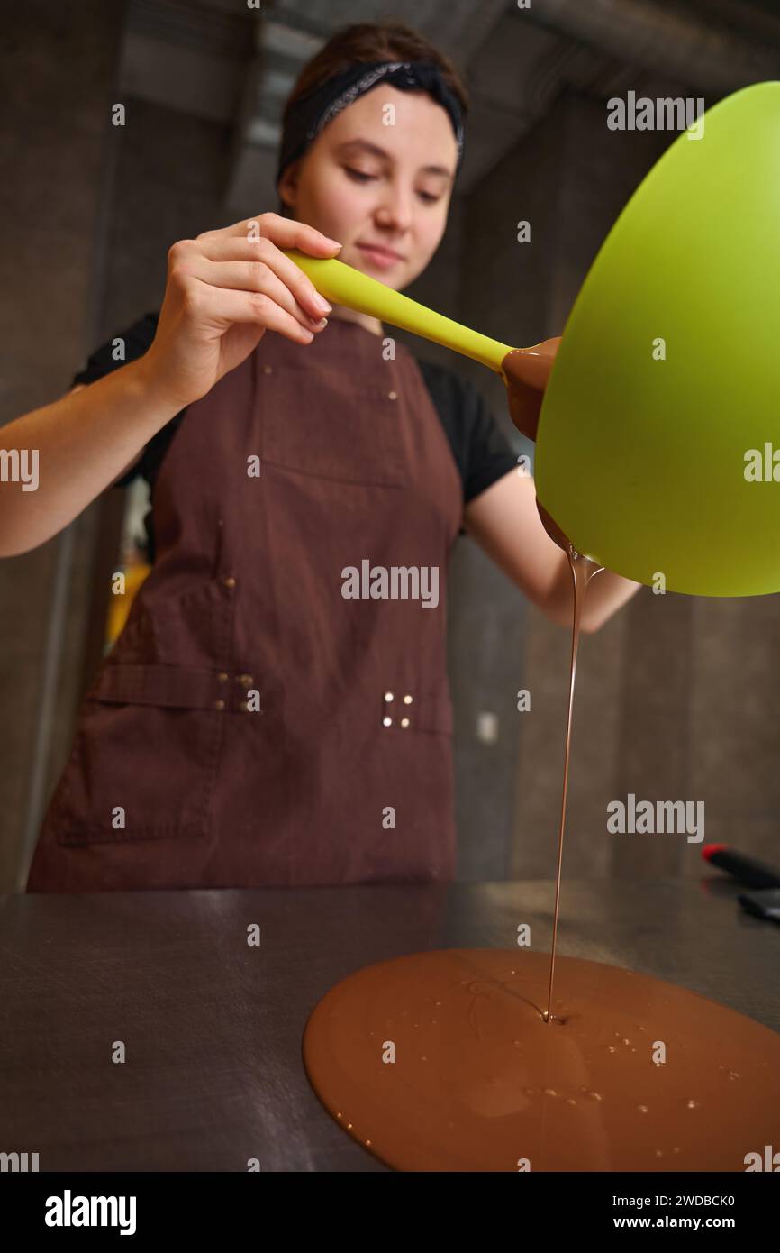 Serious female chocolatier engaged in making candies Stock Photo - Alamy
