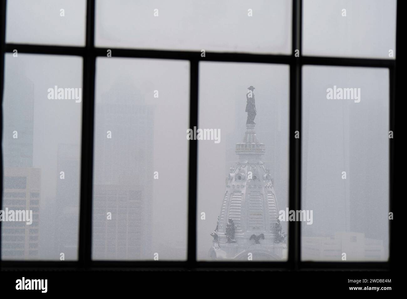 A view through the window of the Loews Hotel sees snow falling on City ...