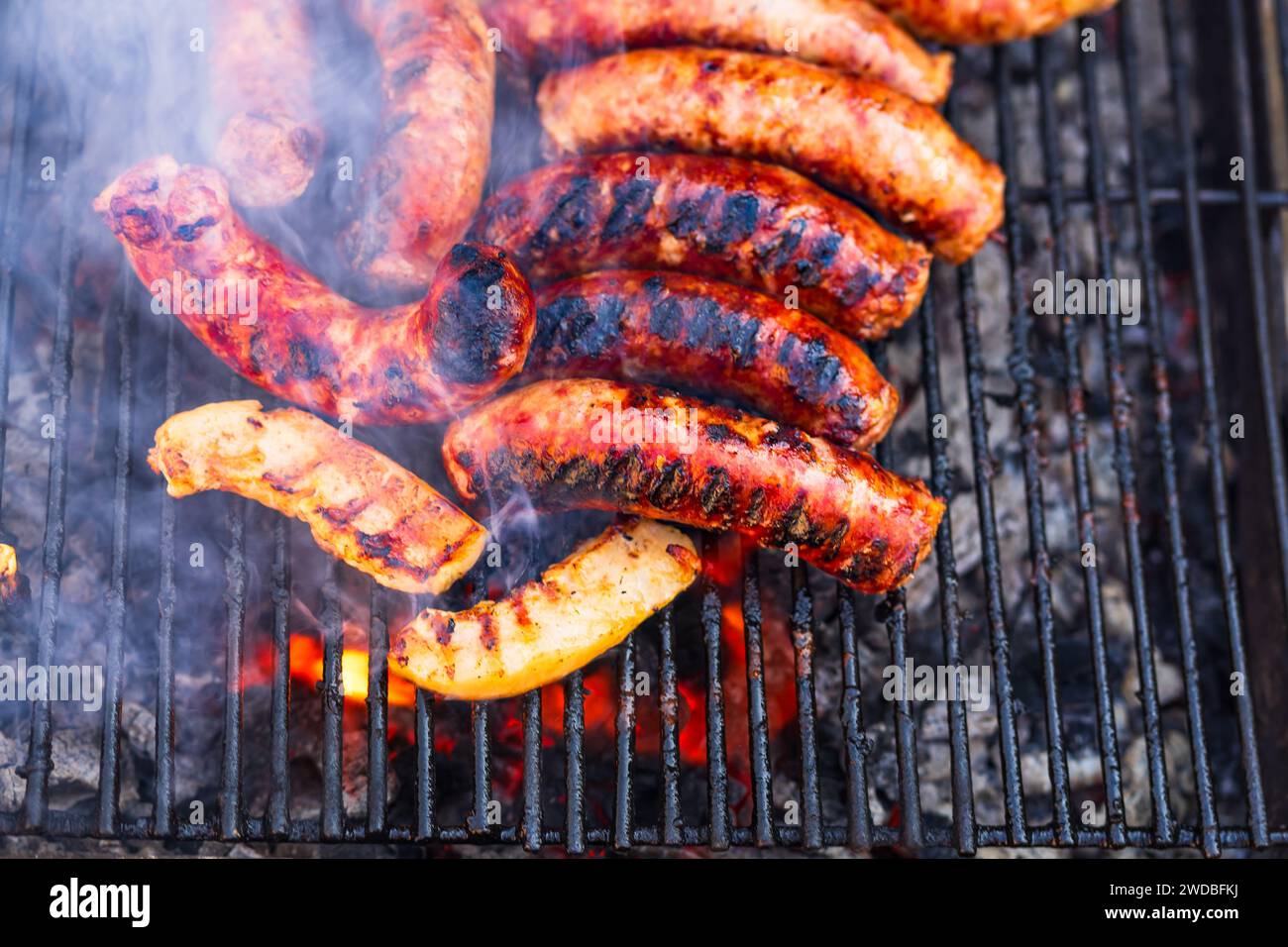 Grilling sausages on barbecue grill. Delicious sausages on charcoal ...