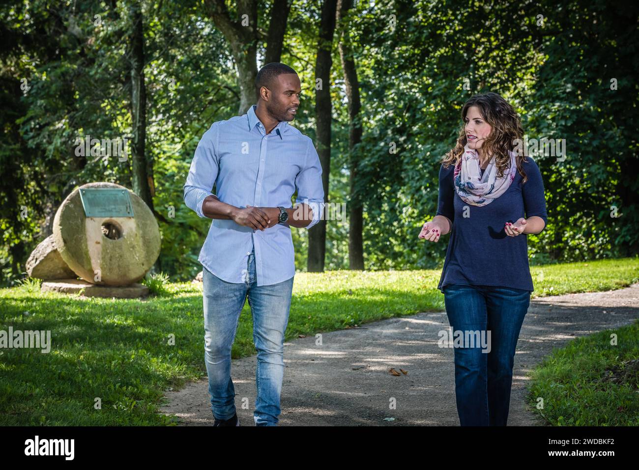 Happy interracial couple walking talking hi-res stock photography and ...