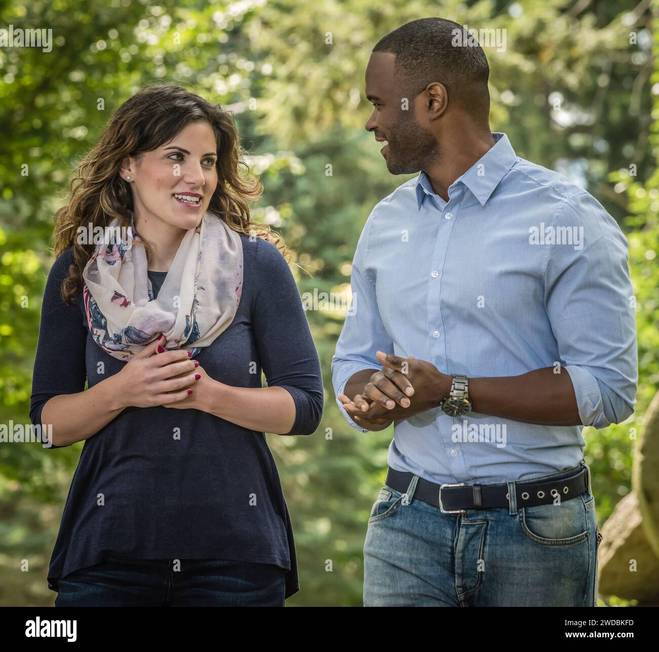 Happy interracial couple walking talking hi-res stock photography and ...