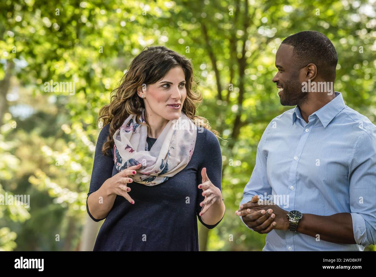 Happy interracial couple walking talking hi-res stock photography and ...