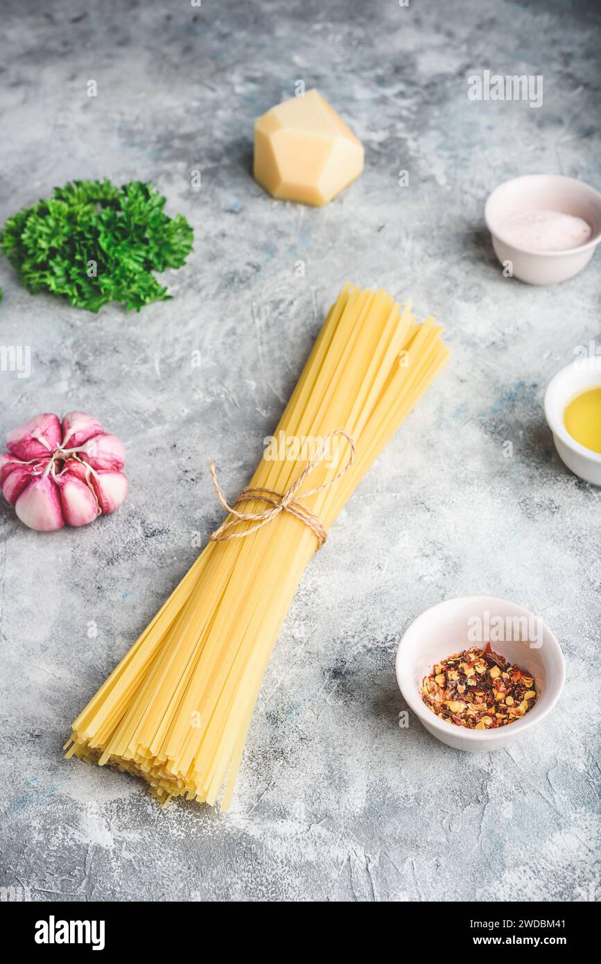 Raw ingredients for cooking linguine with olive oil, garlic and parsley ...
