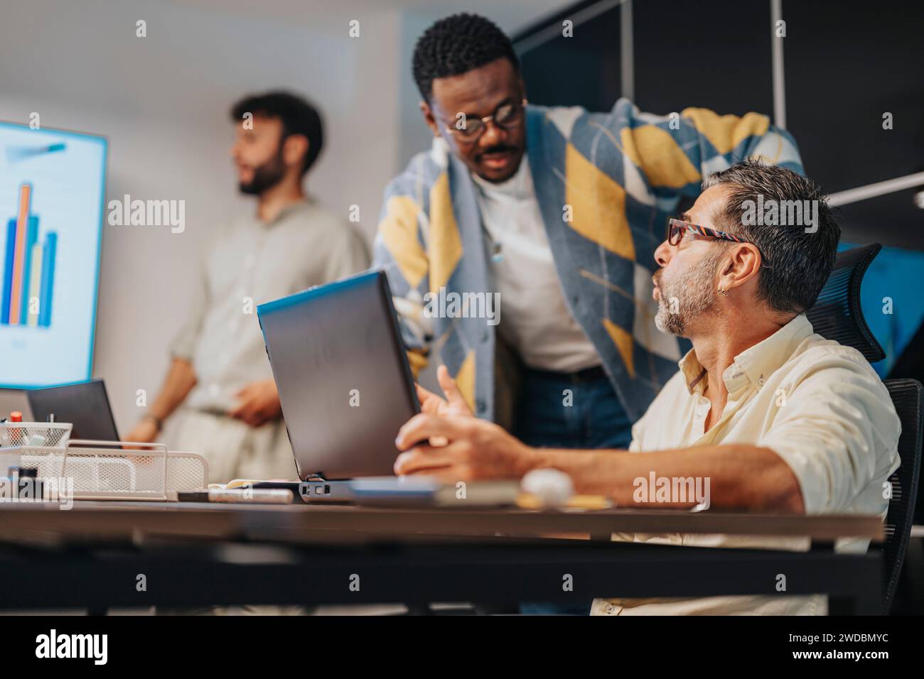 Professionals discuss and collaborate in a conference room, utilizing ...