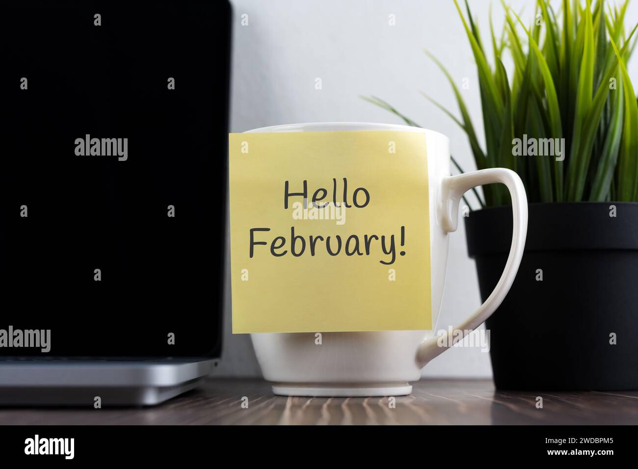 Hello February on adhesive note stick on coffee cup Stock Photo - Alamy