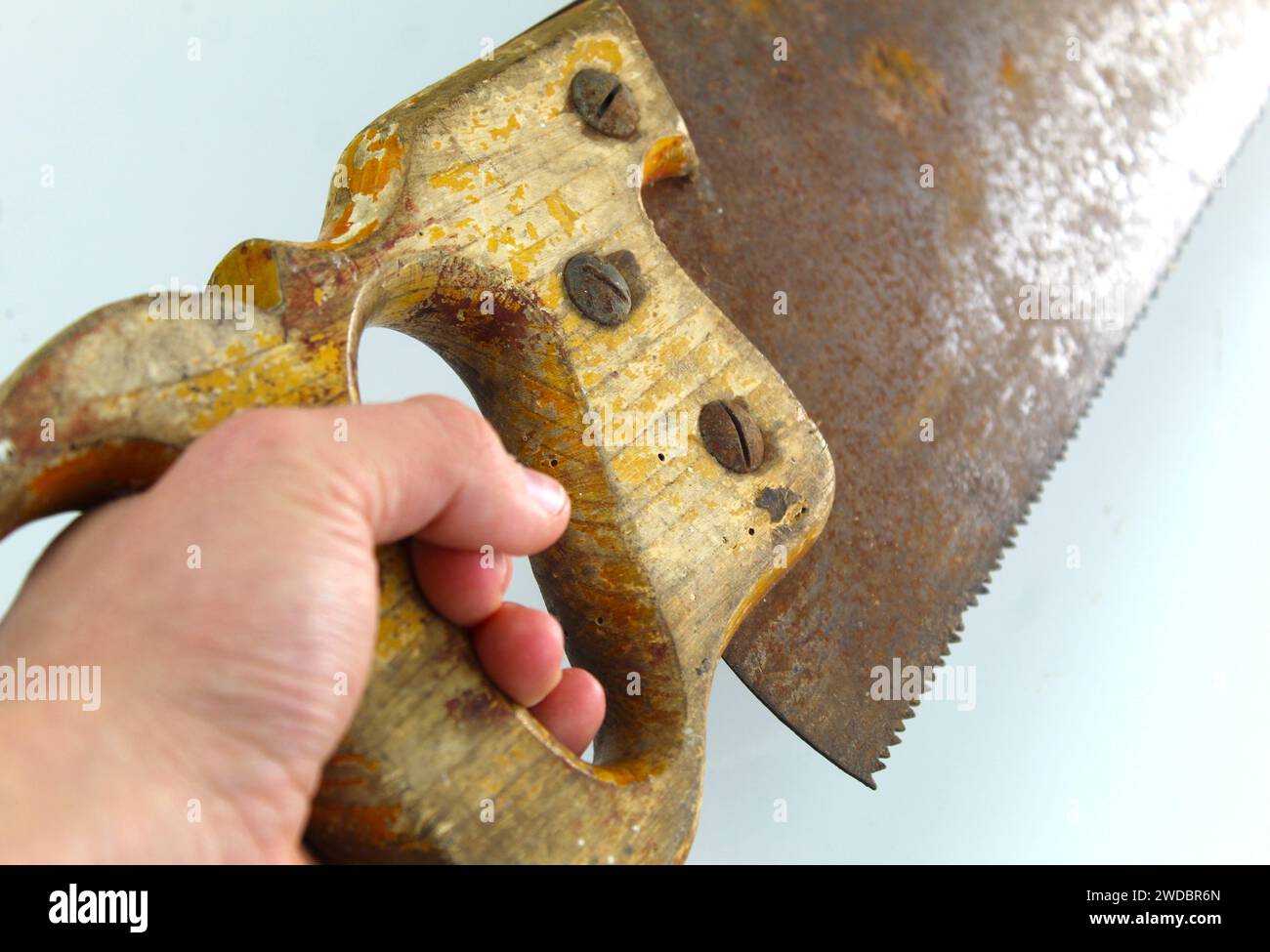 A close up photo of someone holding a saw Stock Photo - Alamy