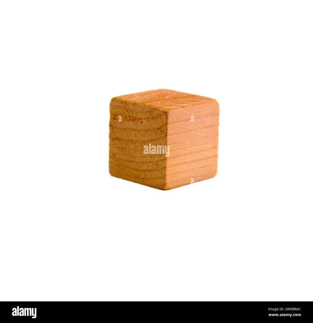 A close up photo of a small wooden block on a white surface Stock Photo ...
