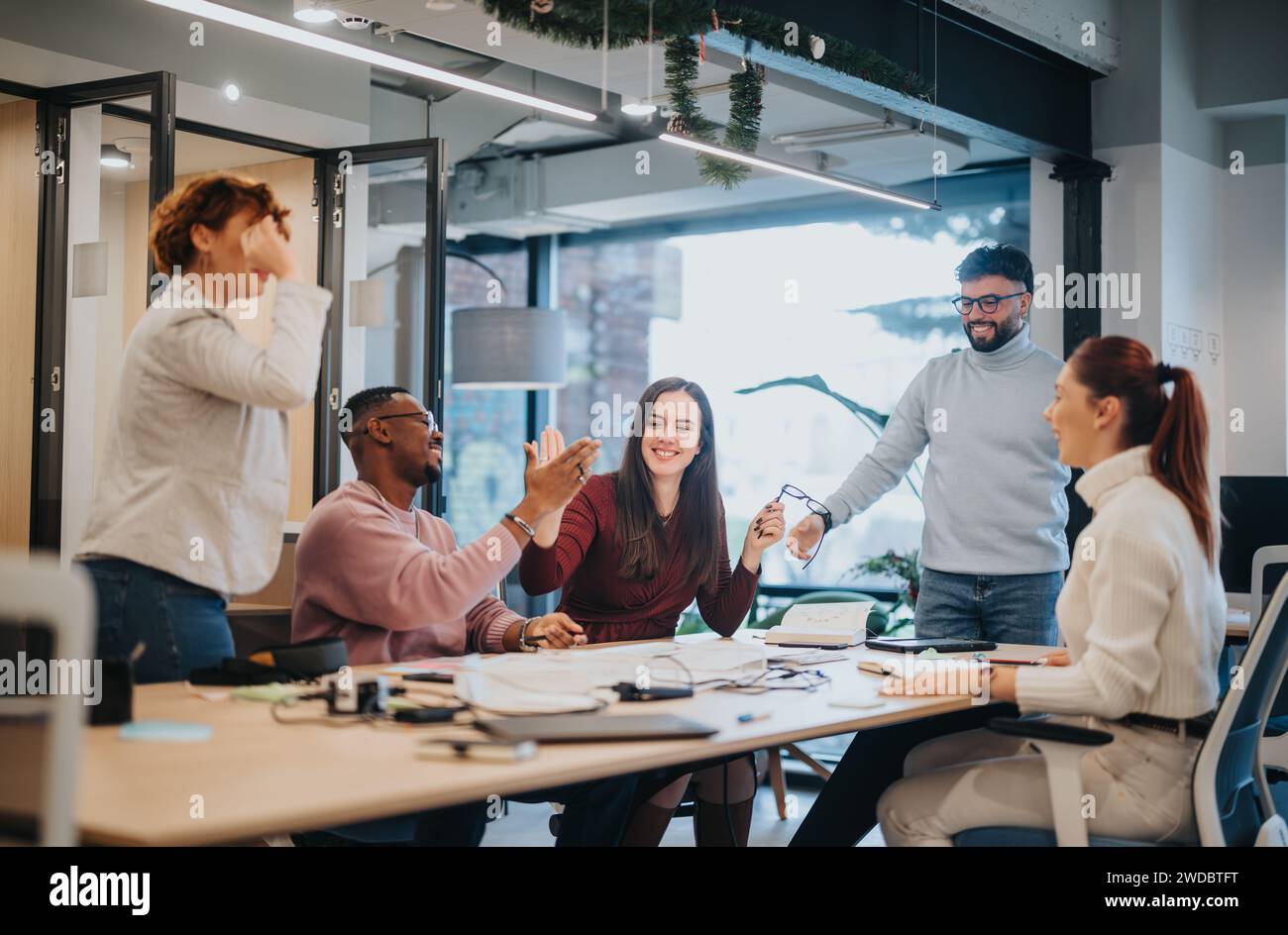 Multicultural coworkers celebrate successful finished project with joy ... Multicultural coworkers celebrate successful finished project with joy ...