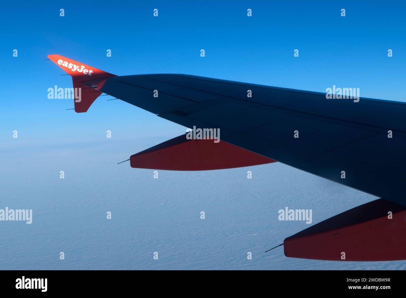 EasyJet logo Easy Jet logo on airplane wing, flying above clouds blue ...