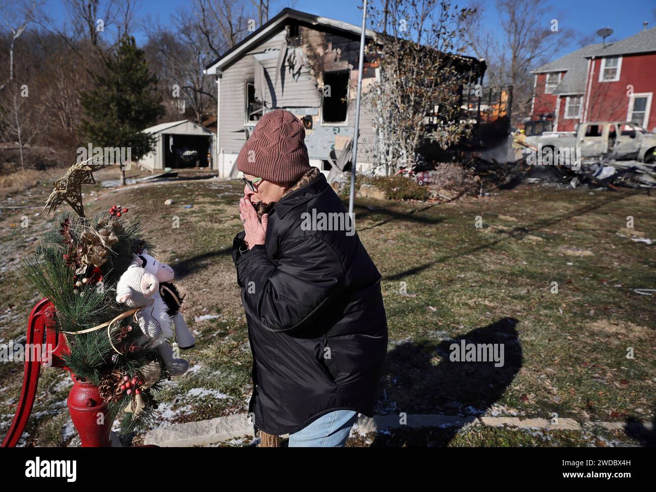 Laura Emerson, of Defiance, kisses her hands and gestures to a memorial ...