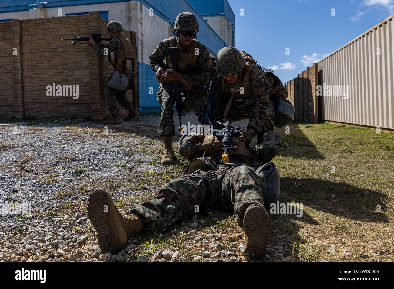 U.S. Marines with Marine Wing Headquarters Squadron (MWHS) 1 drag a ...