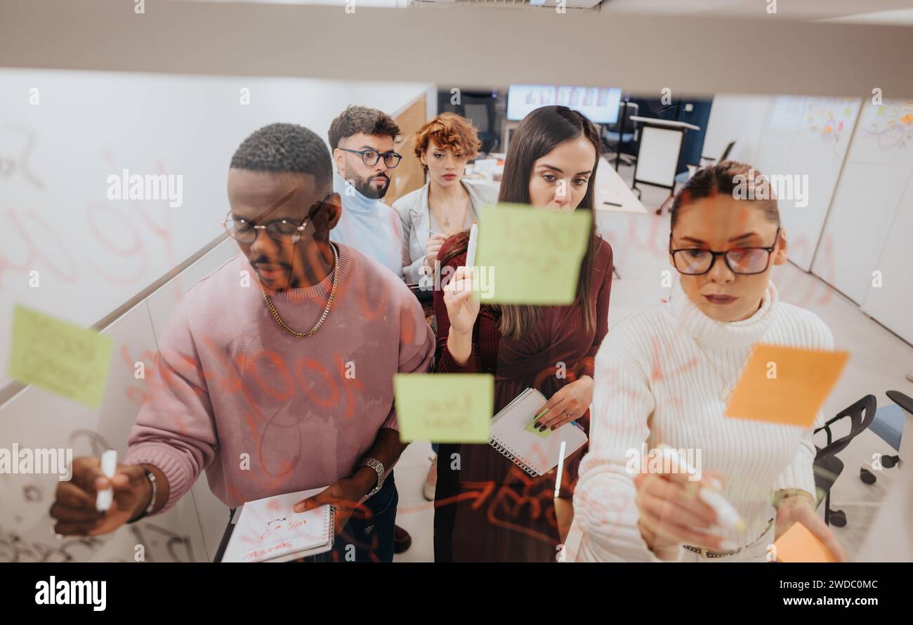 Business professionals in a glass-walled office collaborating, problem ...
