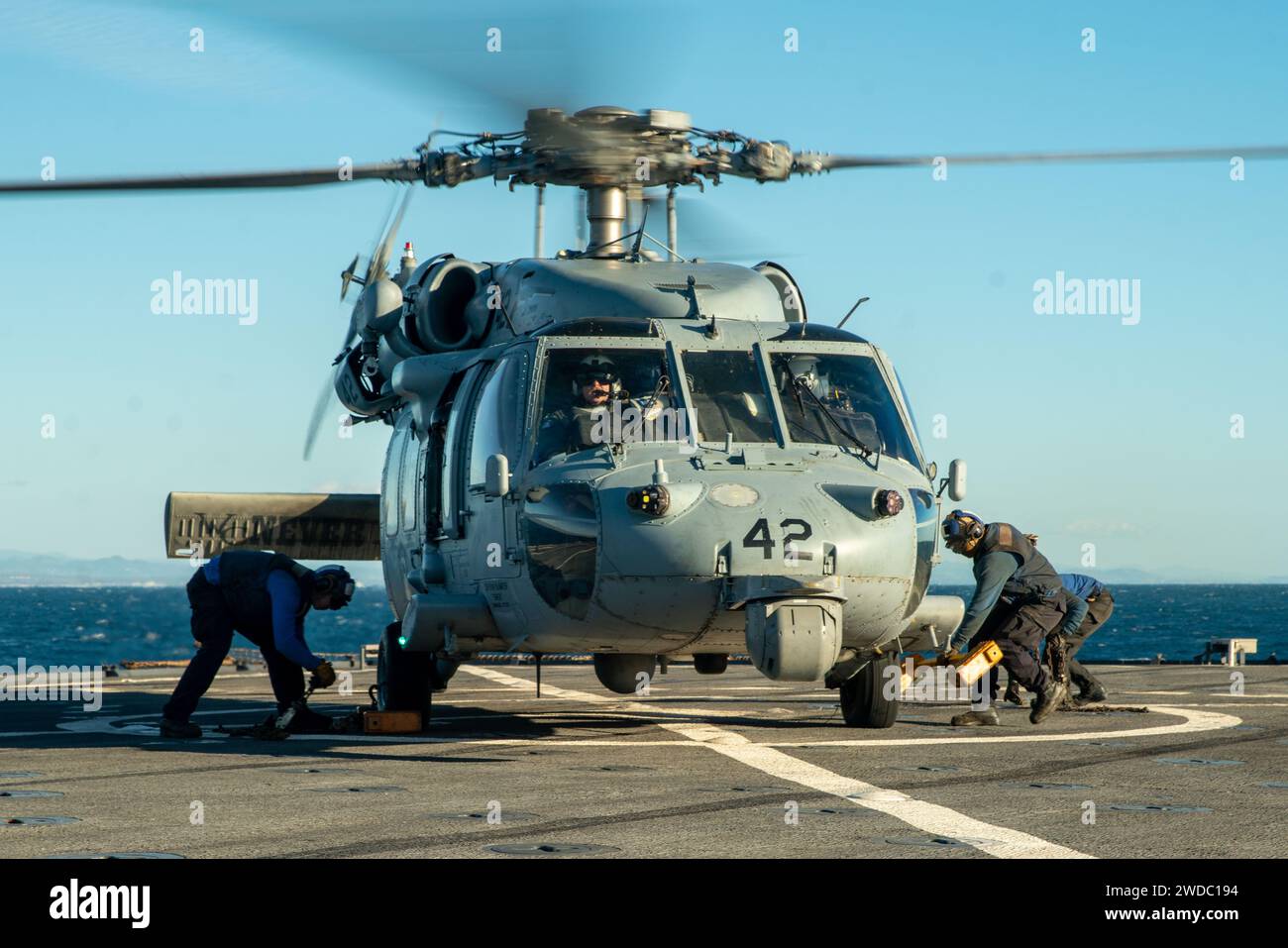 U.S. Sailors assigned to amphibious dock landing ship USS. Harpers ...