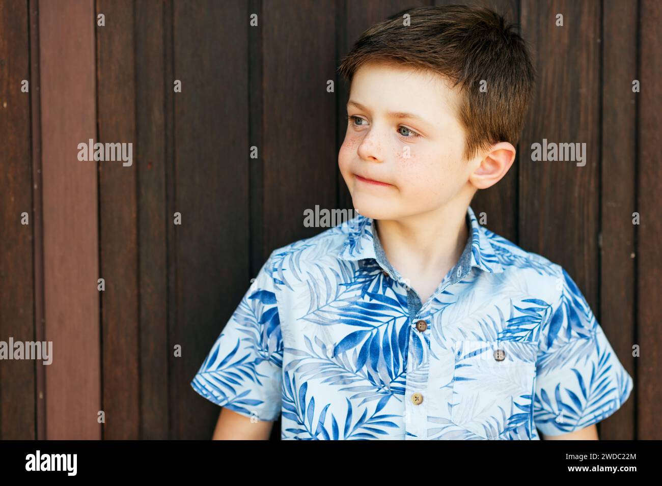 Funny stylish kid boy posing outdoors, wearing blue print shirt Stock ...