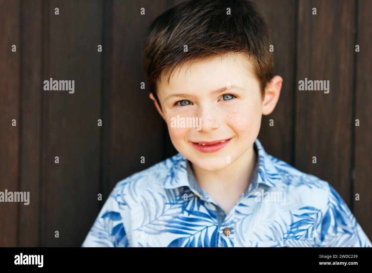 Funny stylish kid boy posing outdoors, wearing blue print shirt Stock ...