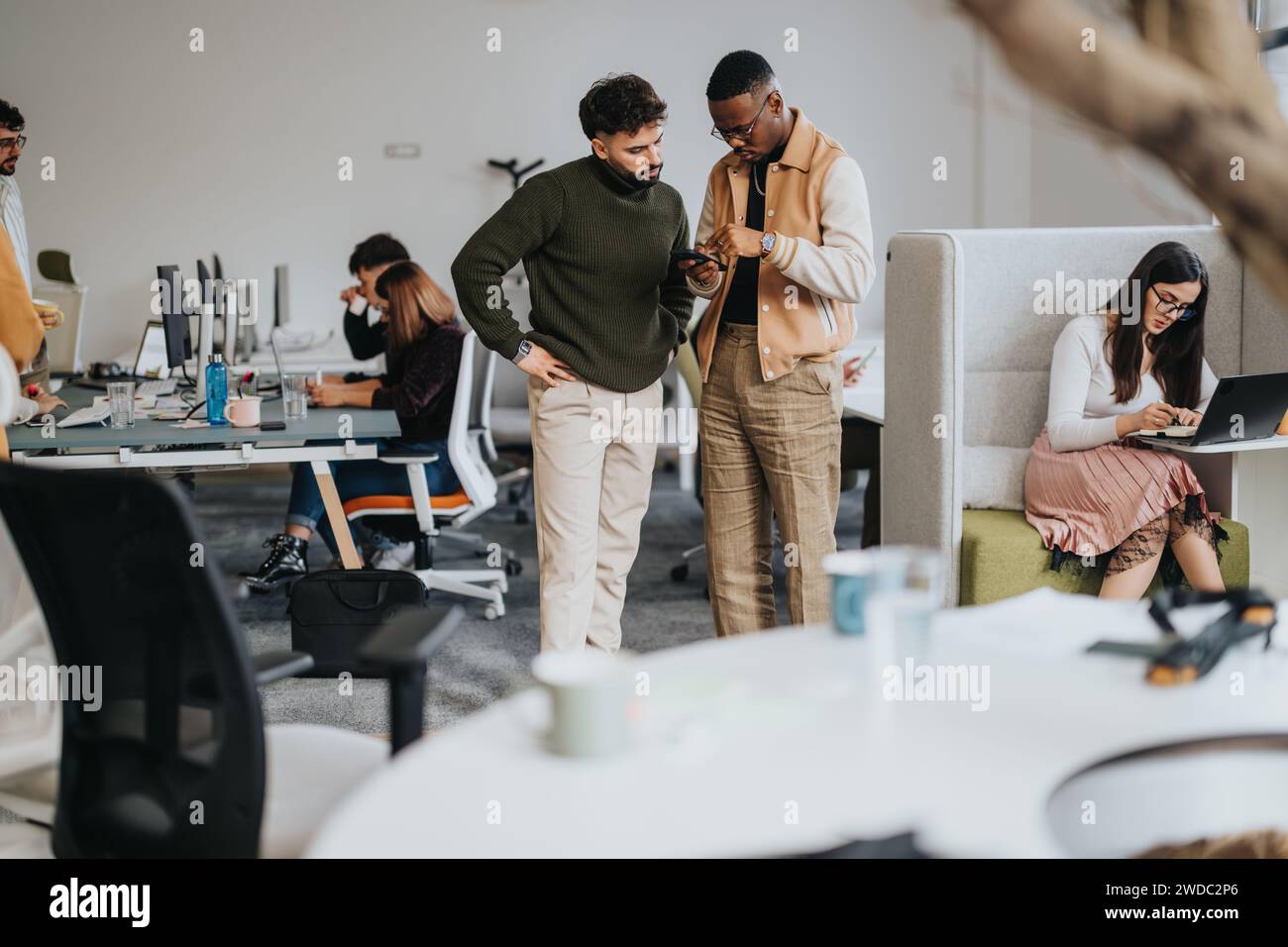 Business coworkers collaborating on market analysis and brainstorming strategies for financial ...