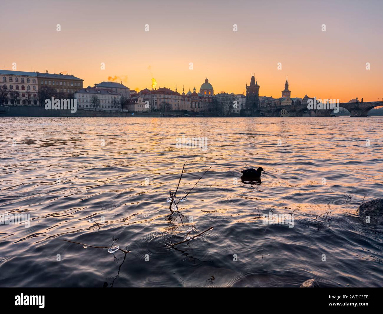 Winter frosty dawn over Prague. Picturesque golden glow and winter haze ...
