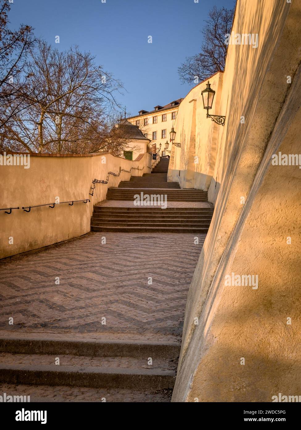 Morning journey up the Castle steps to Prague Castle. Winter twilight ...