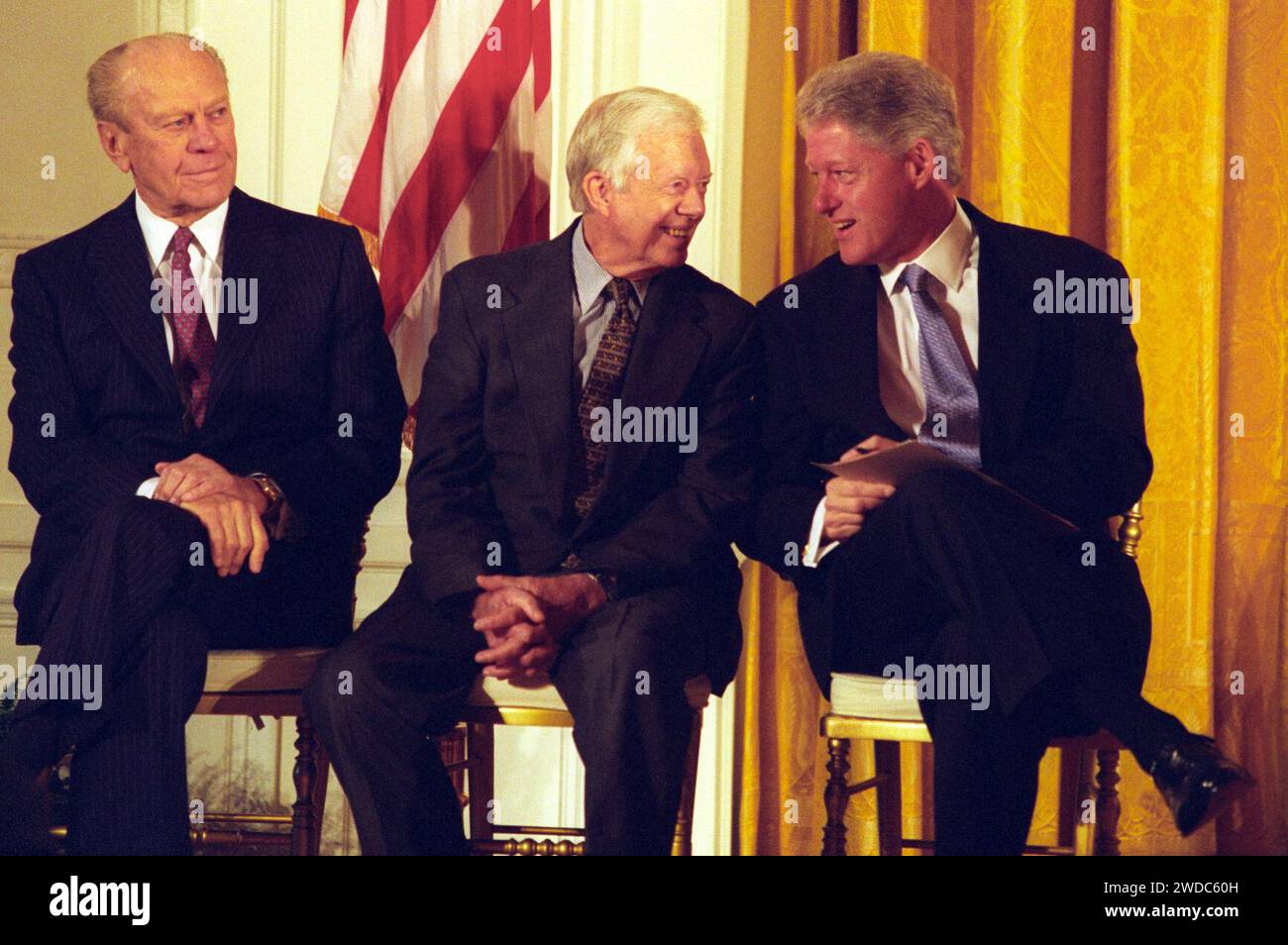 President Bill Clinton talks with former President Jimmy Carter as ...