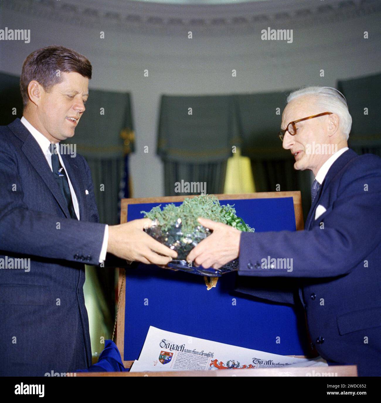 President John F. Kennedy being presented an arrangement of shamrocks ...