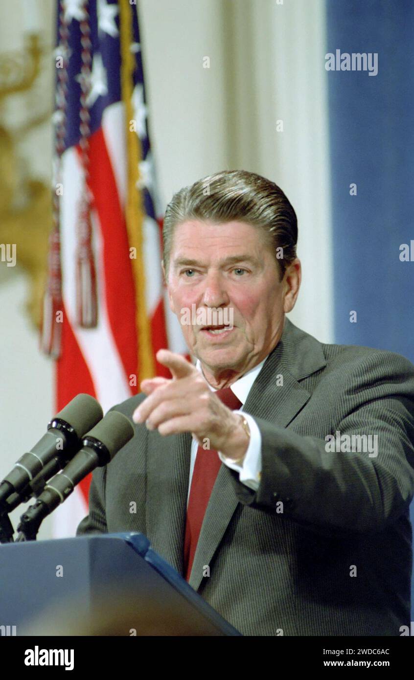 President Ronald Reagan pointing from podium during 13th Press ...
