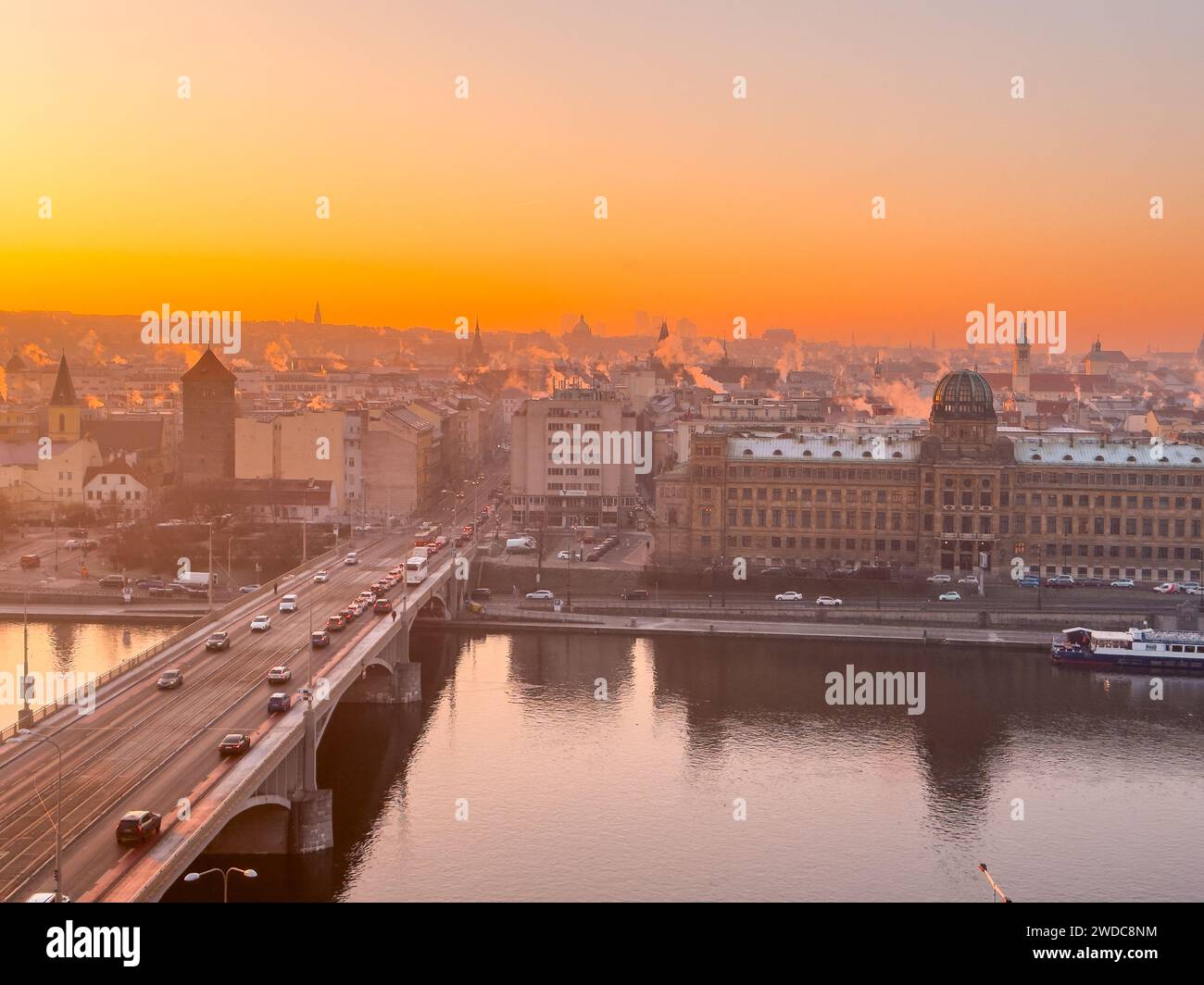 Winter frosty dawn over Prague. Picturesque golden glow and winter haze ...