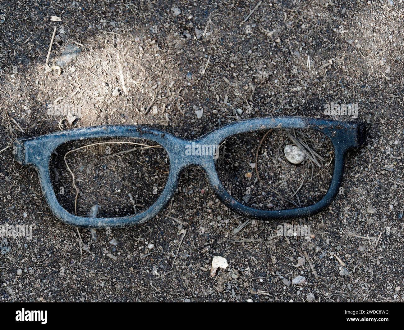 A broken pair of glasses lies on the dirty tarmac Stock Photo - Alamy