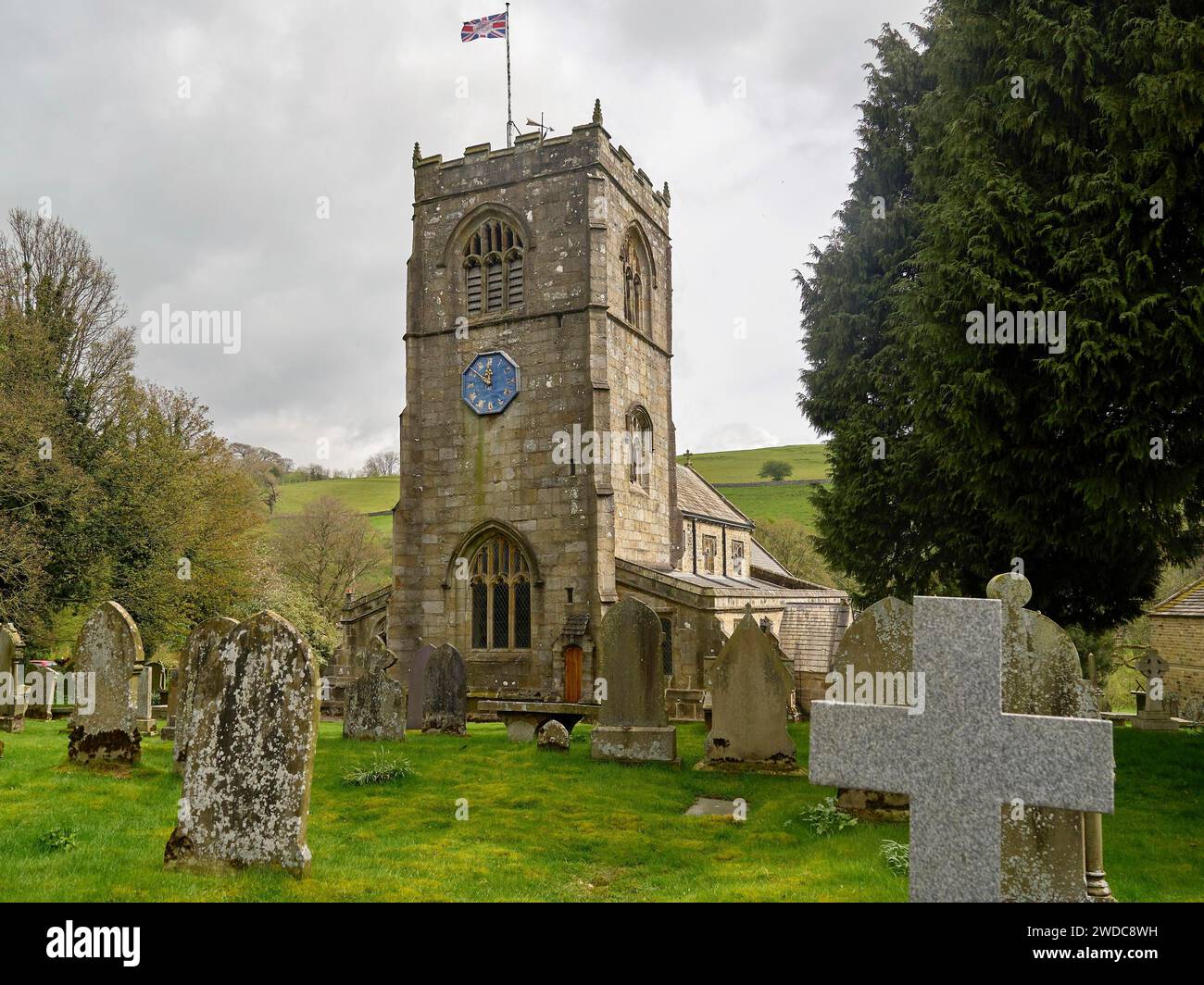 View of a traditional British church and graveyard with Gothic ...