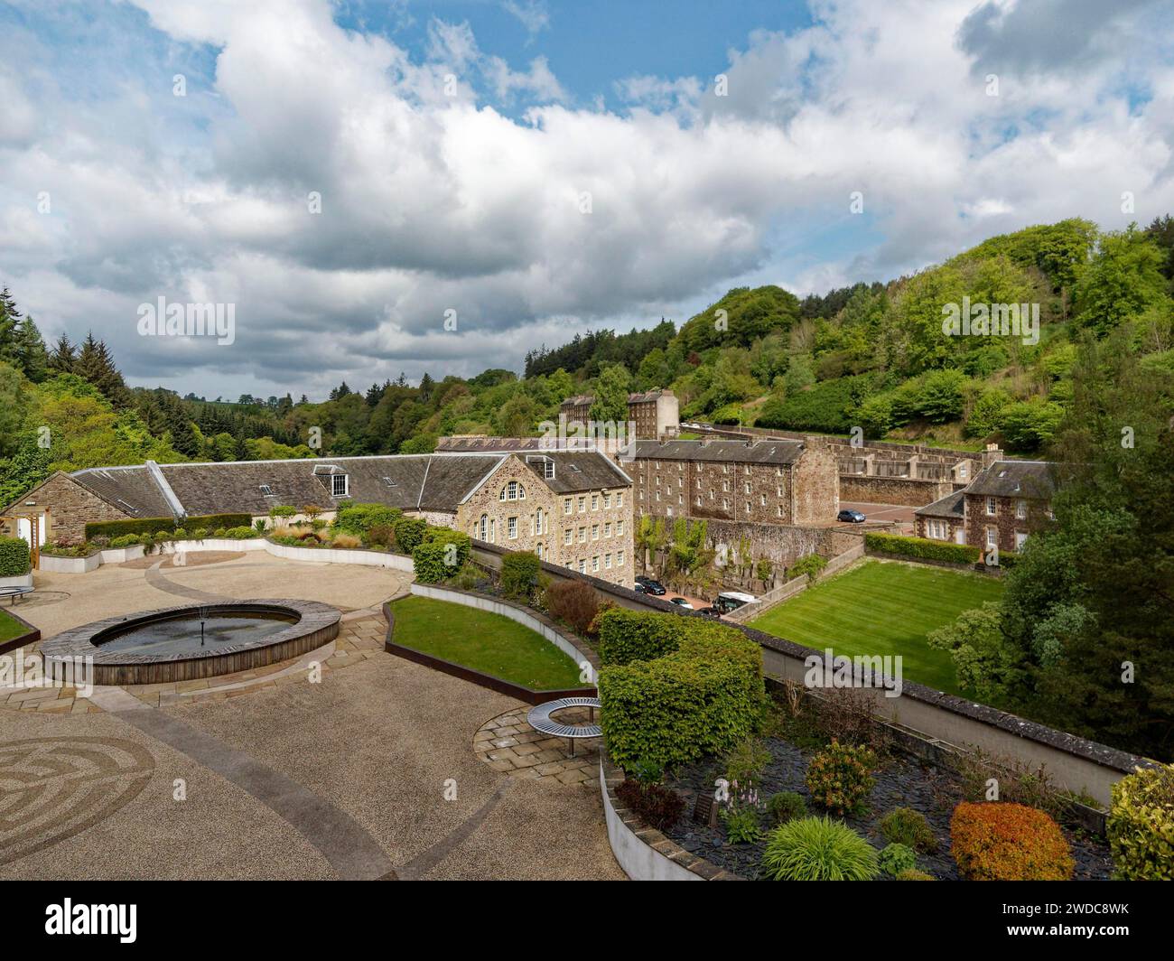 View of historic buildings with landscaped gardens under a cloudy sky ...