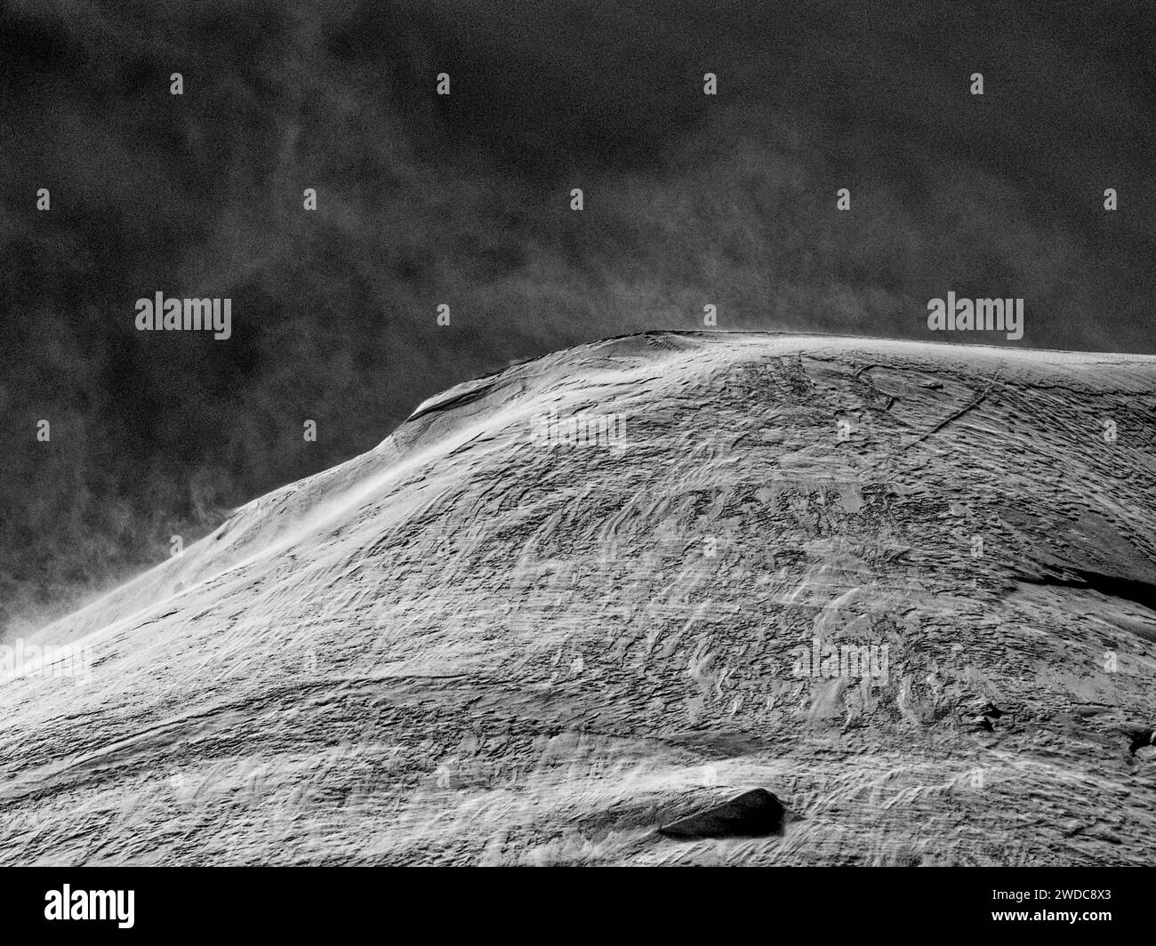 A black and white image of a mountain ridge with strong texture and ...
