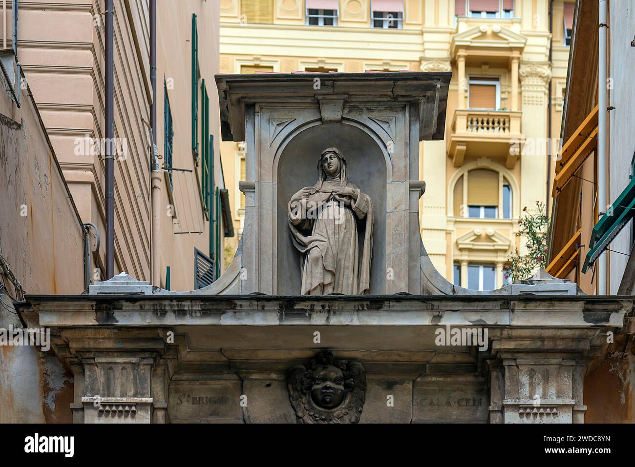 Sculpture of the Holy Madonna above an archway in the historic centre ...