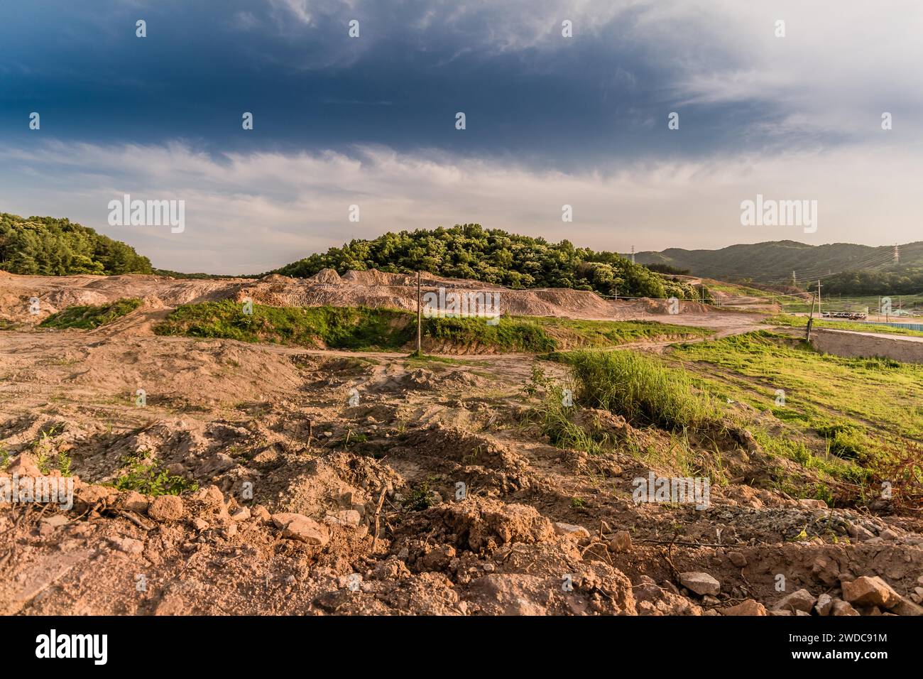 Barren area of land that has been cleared for development with lush ...