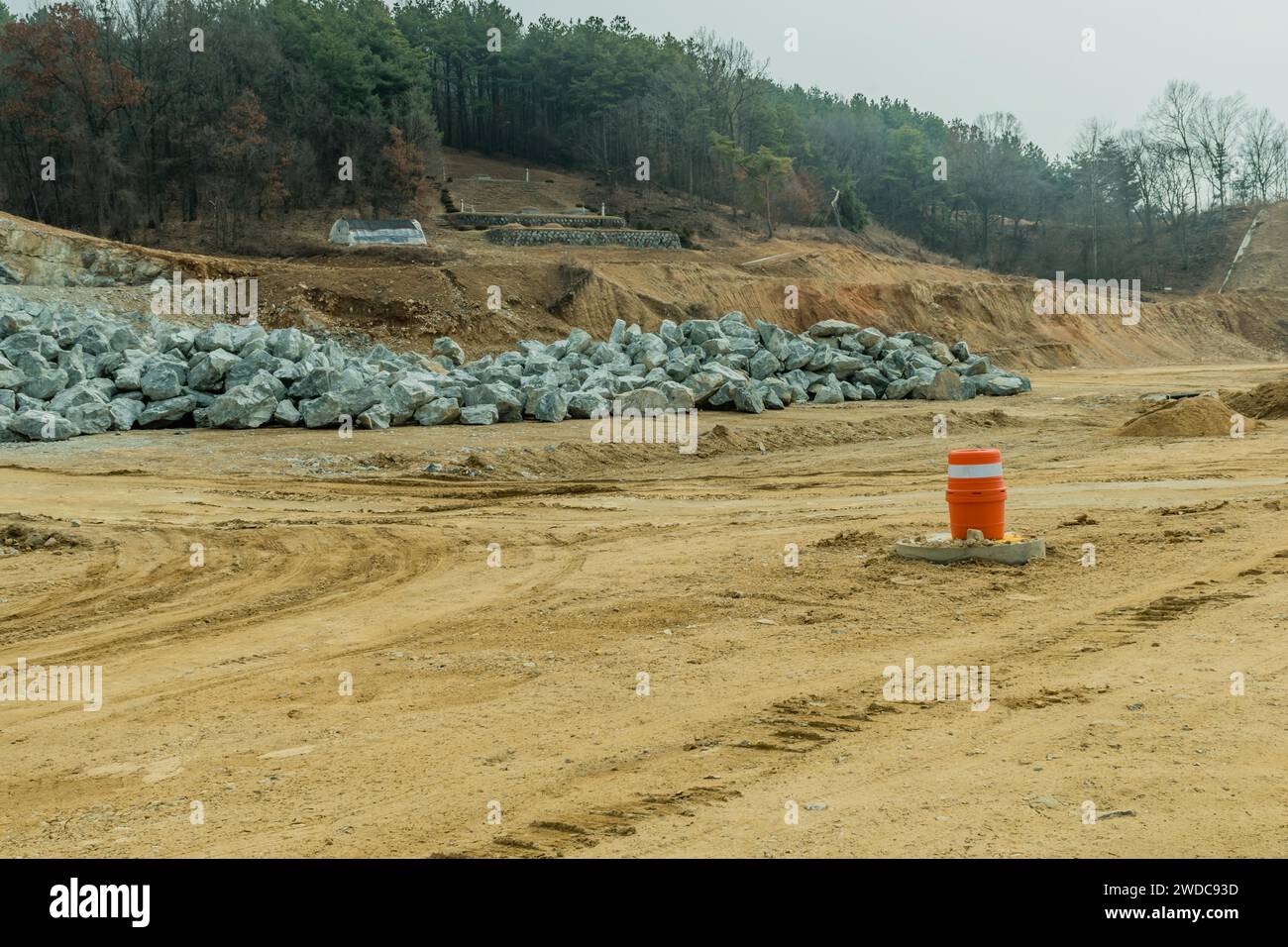 Pile of quarried boulders at construction site with burial site near ...