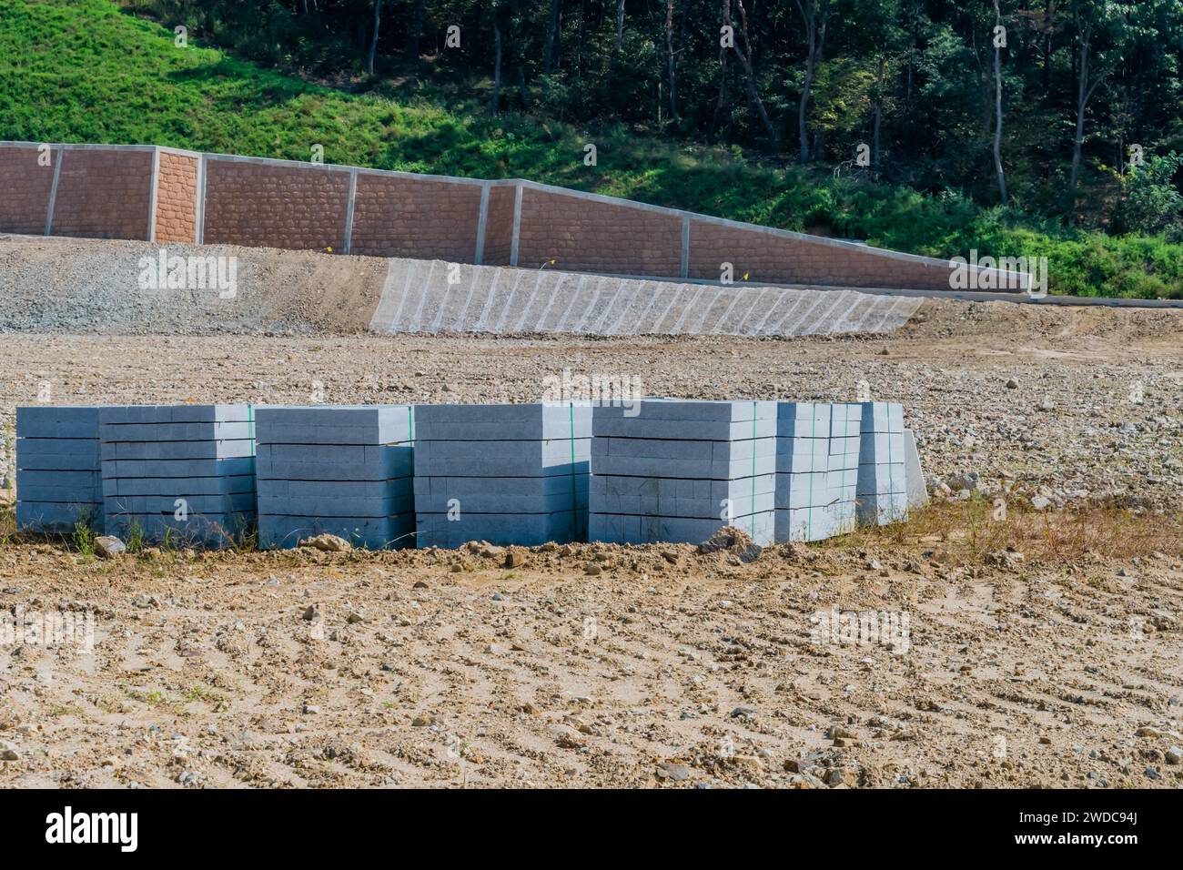 Stacks of concrete blocks sitting in gravel and dirt lot at ...