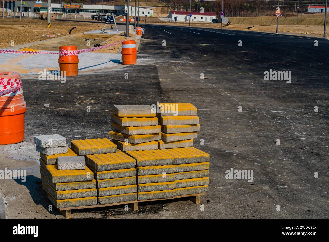 Square preformed concrete blocks with one side painted yellow to be ...