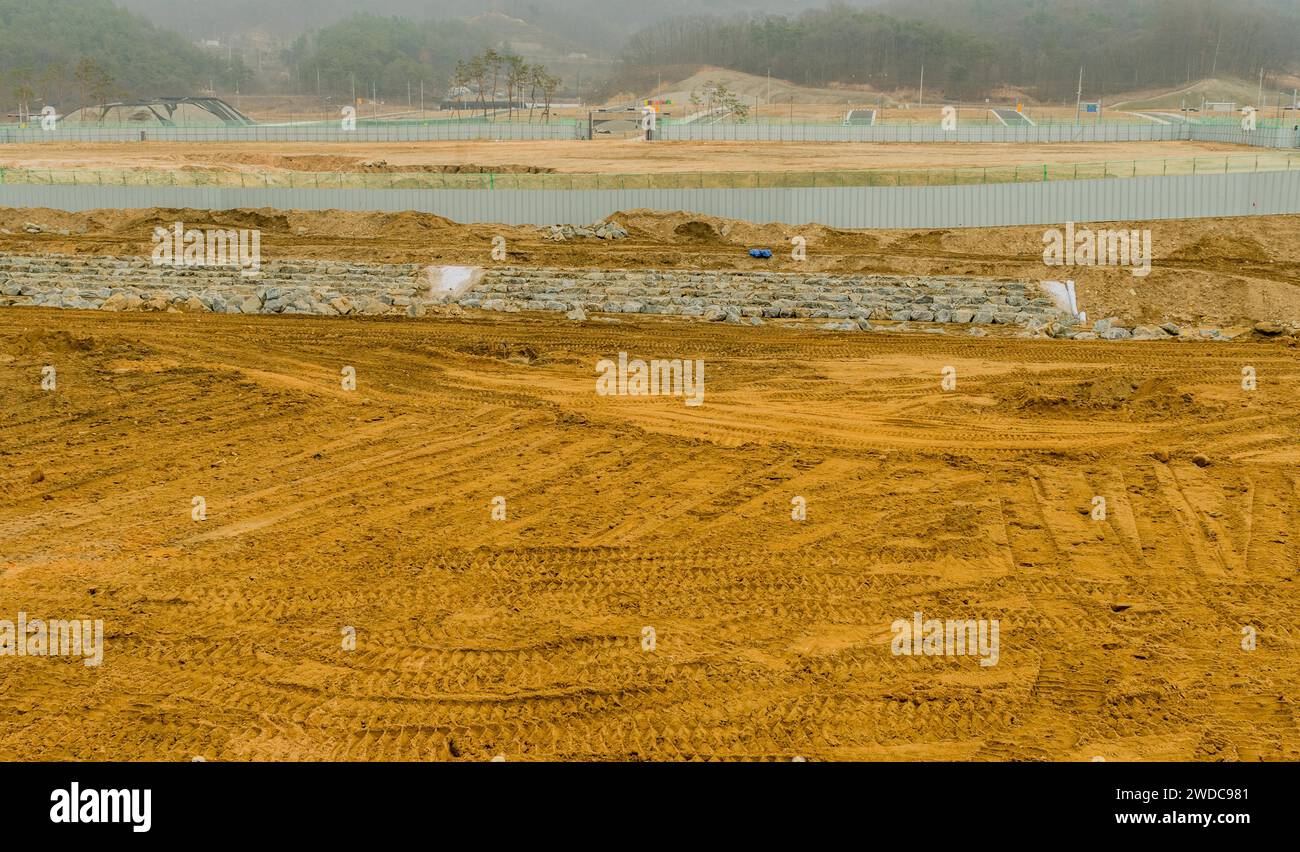 Landscape of new construction site with section fenced off with gray ...