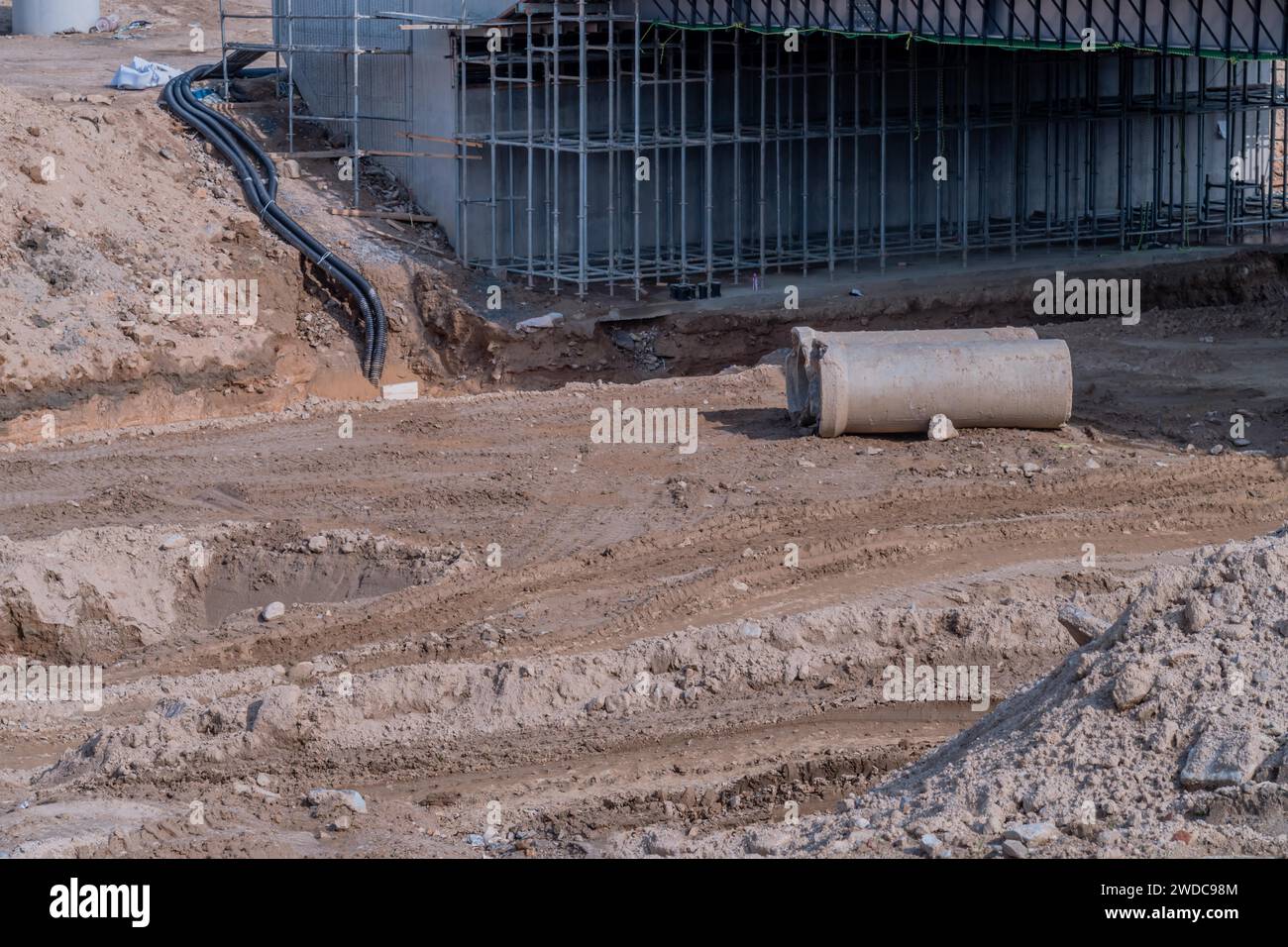 Round concrete culvert sections on ground at construction site with ...