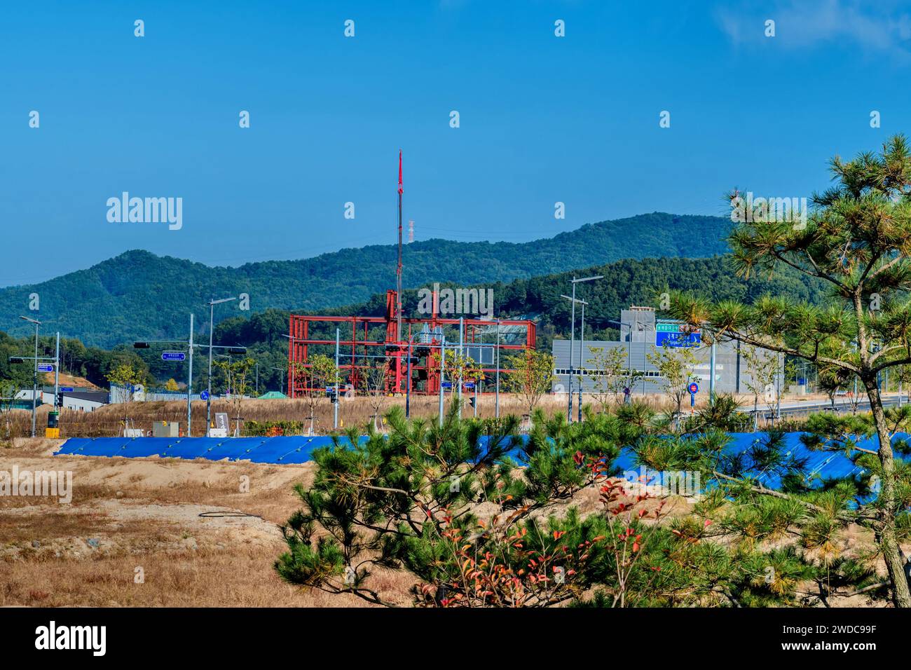 Red metal frame of new building with blue sky in background, South ...