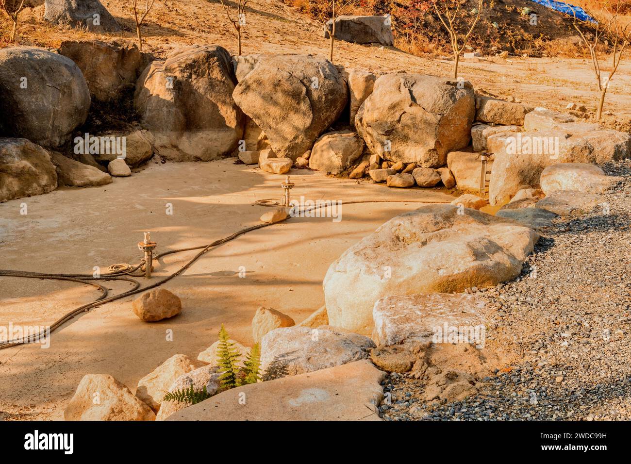 Sprinkler heads for fountain and electrical cables on ground of ...